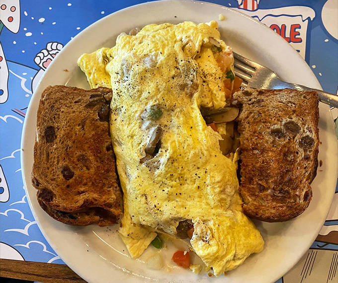A veggie omelet that could convert carnivores &ndash; fluffy eggs embracing fresh vegetables with raisin toast standing guard on either side.