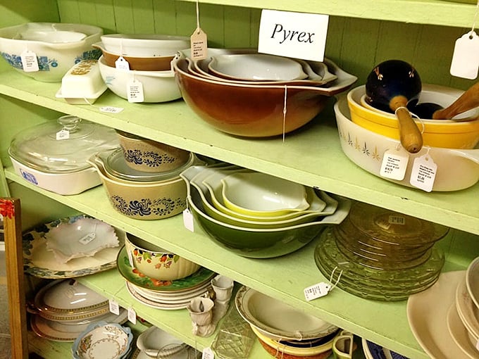 Colorful vintage Pyrex displays create a rainbow of kitchen nostalgia, tempting collectors with their timeless designs and sturdy functionality.