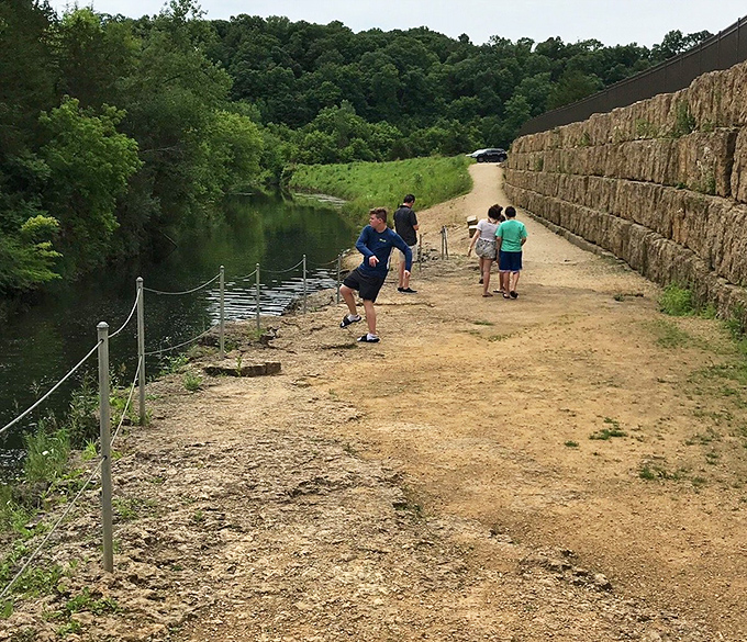 Visitors gather along the water's edge, proving that standing around watching falling water never gets old.