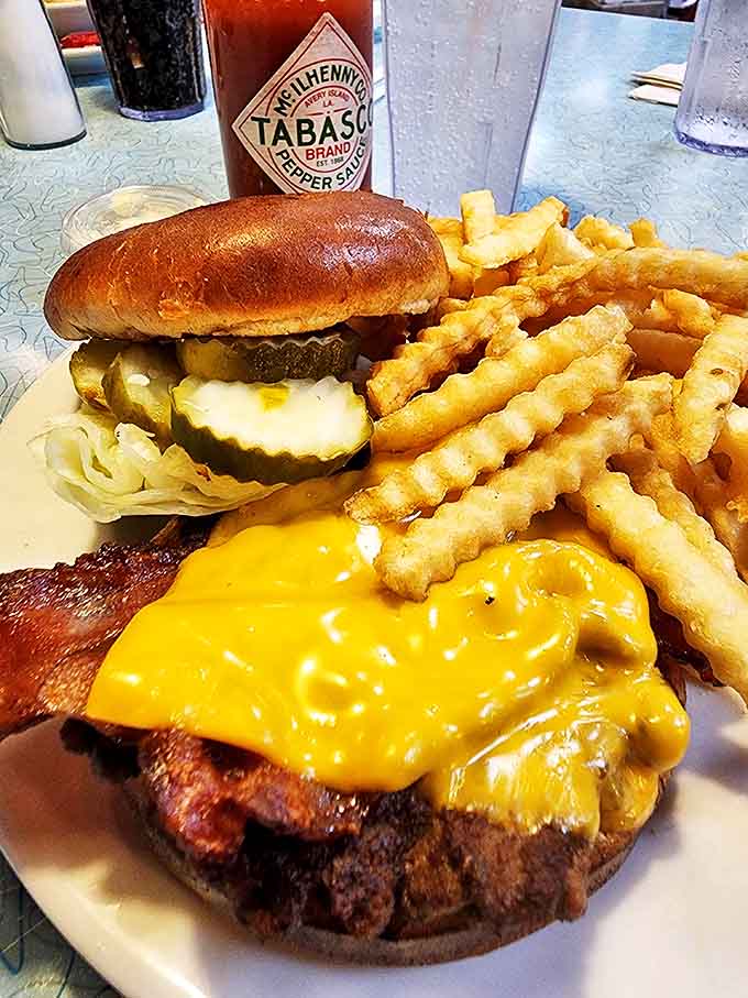 This isn't just a burger &ndash; it's edible architecture with melted cheese cascading down the sides like a yellow waterfall of happiness.