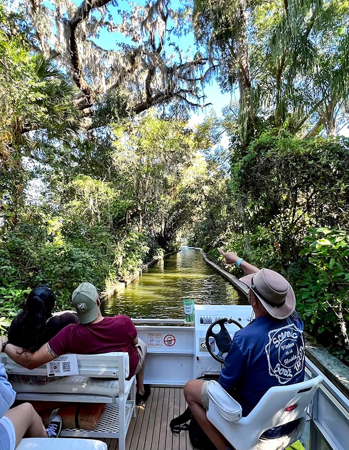 Aquatic caravan: Fellow explorers paddle ahead through the living corridor of greenery, each experiencing their own moment of discovery.