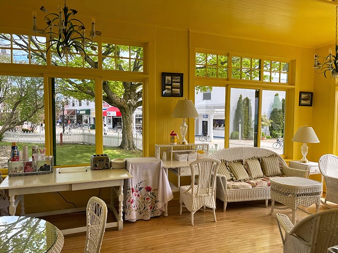 Sunlight streams through windows into this breakfast area, where wicker furniture and yellow walls promise a cheerful start to island adventures.