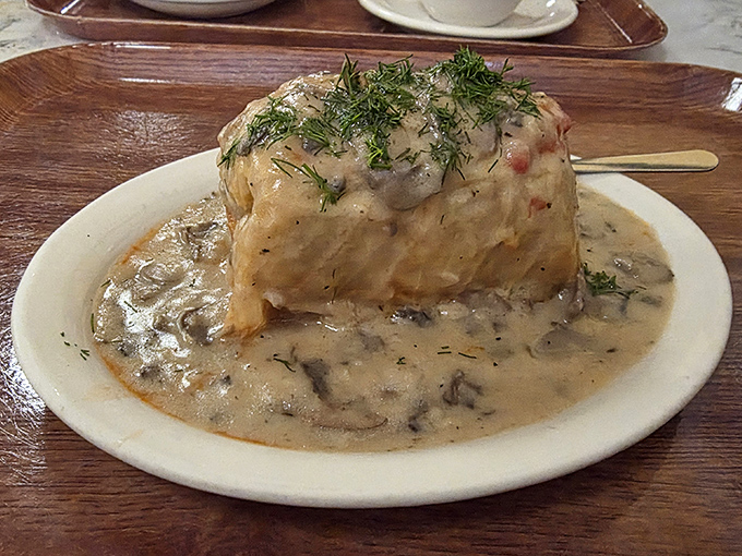 This isn't just any cabbage roll &ndash; it's a masterpiece of tender cabbage embracing savory filling, all swimming in mushroom cream sauce.