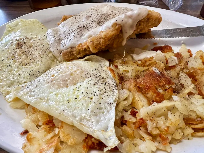 Country fried steak smothered in peppery gravy alongside golden hash browns and eggs &ndash; the breakfast of champions or the reason for your afternoon nap.
