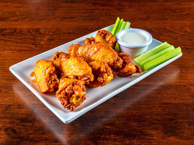 These wings aren't flying anywhere except straight to your taste buds, accompanied by crisp celery sticks standing at attention.