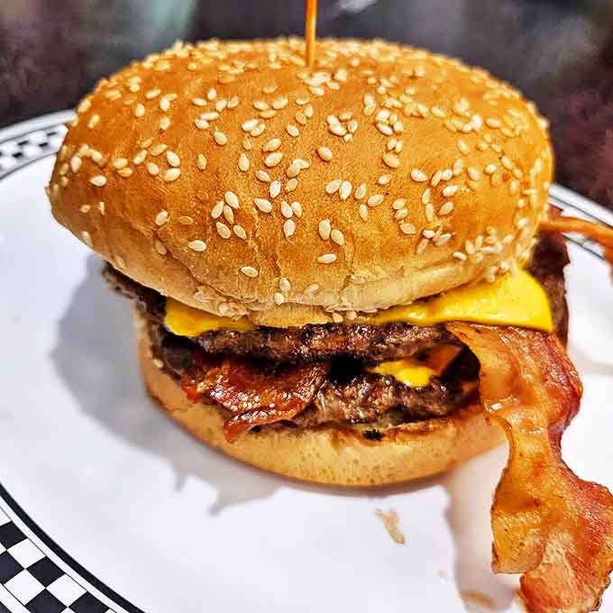 This isn't just a burger&mdash;it's architecture with cheese, where bacon plays peek-a-boo and every bite requires a strategy and several napkins.