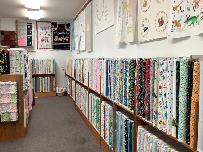 Quilts displayed throughout the store aren't just merchandise – they're inspiration incarnate, showing what's possible with patience and the right materials.