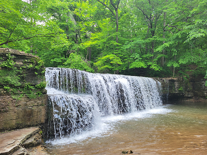 Water doesn't just fall here – it performs an elegant dance down limestone steps that geology spent millions of years choreographing.