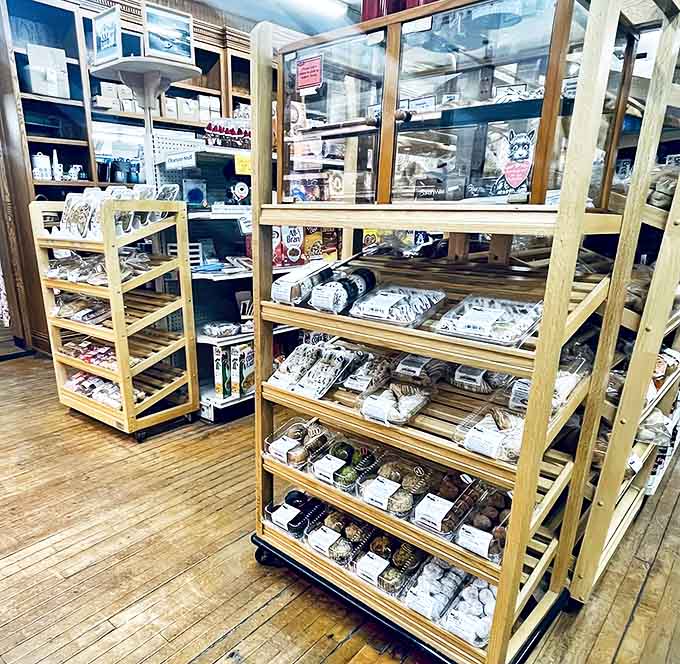Fresh-baked goods await behind glass, their perfect frosting and golden crusts promising moments of sweet, buttery bliss.