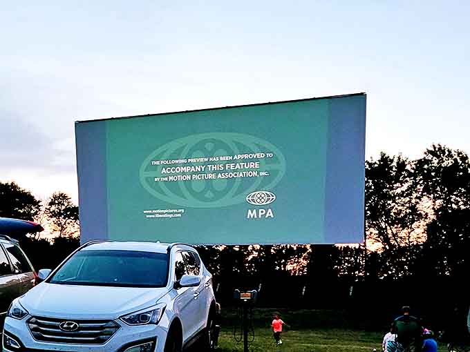 As dusk settles over the countryside, the massive screen awaits its transformation into a window to other worlds.