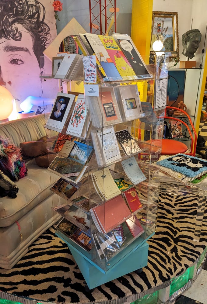Clear acrylic displays showcase an artistic array of greeting cards and prints&mdash;perfect for the friend who deserves better than a text message.