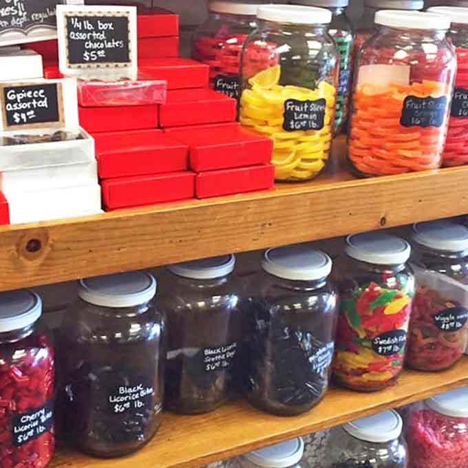 Colorful jars of gummies and candies line the shelves like an edible rainbow, proving that sometimes happiness is as simple as a jar of perfectly made sweets.