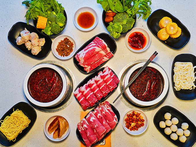 A feast for both eyes and stomach! This spread of thinly sliced meats, fresh vegetables, and bubbling broths transforms dining into an interactive celebration.