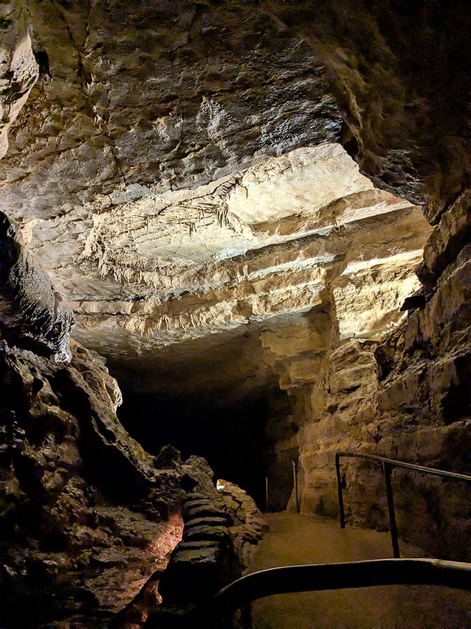 Massive rock formations tower overhead in the cave's interior, creating a cathedral-like atmosphere that took millions of years to construct.