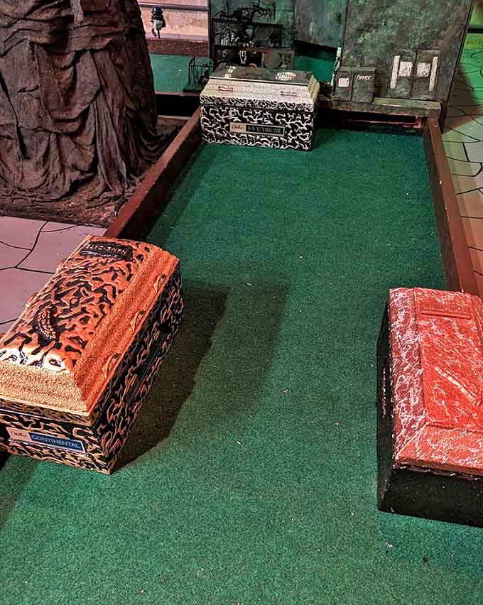 Mini coffins serve as obstacles because regular water hazards are apparently too mainstream for this wonderfully weird course.