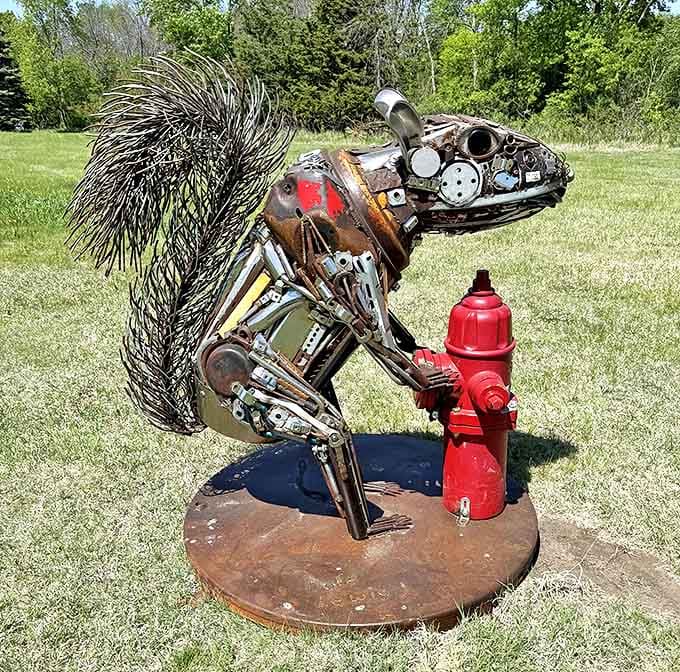 Not your average backyard visitor! This oversized squirrel, complete with magnificent metal tail, stands guard by a fire hydrant "acorn."