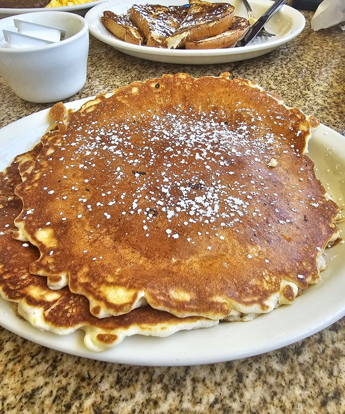 This pancake isn't just big&mdash;it's practically its own zip code, golden-brown and dusted with powdered sugar like morning sunshine.