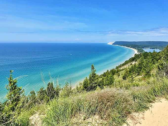Crystal clear waters lap against the dramatic shoreline, creating a photographer's dream where every angle offers postcard-worthy views.