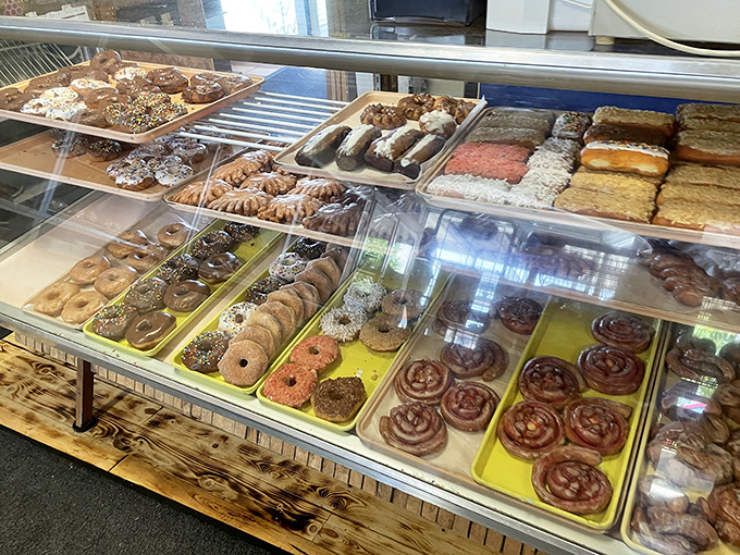 A whole case of sweet temptations&mdash;glazed twists, long johns, and cinnamon rolls so cute they look like they're grinning back at you.