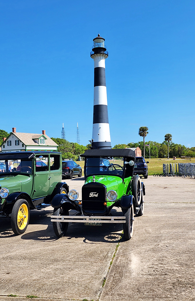 Vintage automobiles add nostalgic charm to the lighthouse grounds, like time travelers parked beneath the towering maritime beacon.