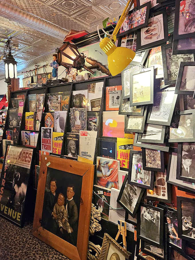 The wall of framed artwork creates a dizzying gallery effect &ndash; from vintage advertisements to forgotten masterpieces, each frame contains its own little universe.