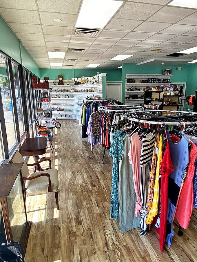 Bright, organized clothing racks at Happy Day's Resale showcase colorful dresses and tops against mint-green walls. Thrifting made joyful!
