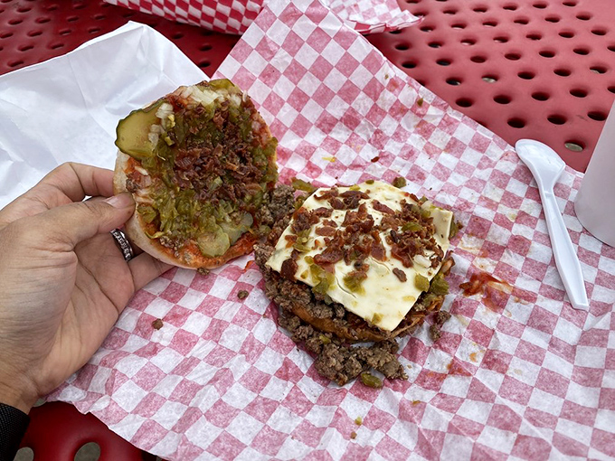 This isn't just a bacon cheeseburger&mdash;it's an architectural marvel of loose meat, melty American cheese, and pickles that somehow defies gravity and common sense.