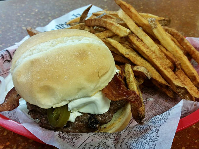 Crispy bacon adds the perfect salty crunch to this classic burger, paired with golden fries that deserve their own fan club.