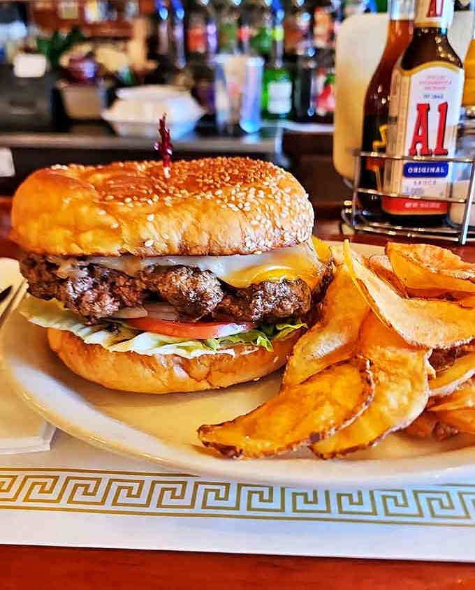 The Bear Burger arrives with golden homemade chips, a mountain of beef perfectly stacked with fresh toppings that make your mouth water before the first bite.