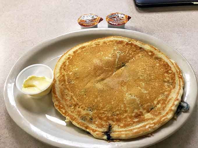Blueberry pancakes with a perfect golden crust &ndash; each berry bursting with flavor in a fluffy dream of breakfast perfection.