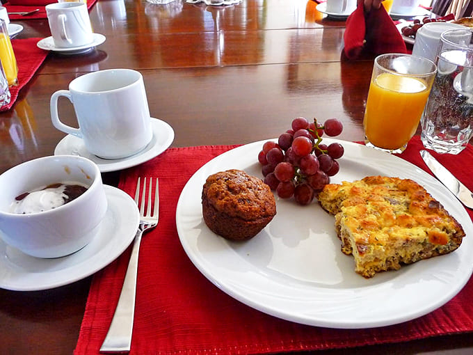 Breakfast with a view! Homemade quiche, fresh muffins, and seasonal fruit start your day right before North Shore adventures begin.