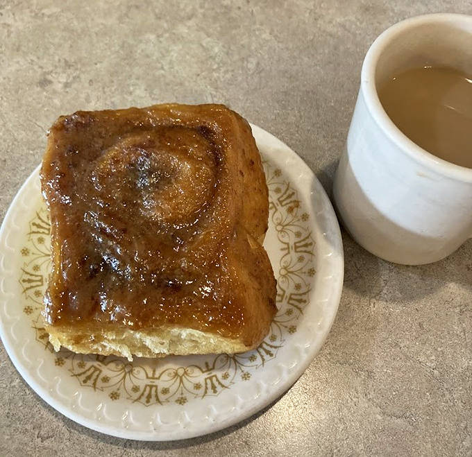Morning perfection: a caramel roll paired with coffee, creating the breakfast duo that launches a thousand smiles.