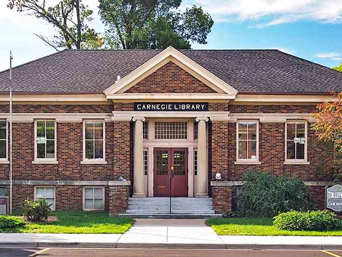 The Carnegie Library, with its stately columns and brick fa&ccedil;ade, houses reading gnomes nestled between classic literature.