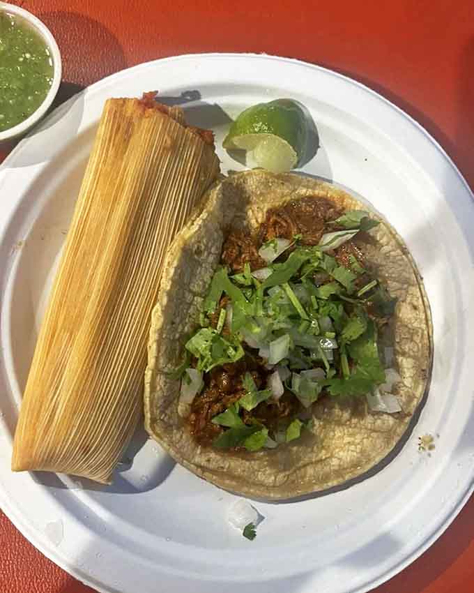 A match made in heaven: handcrafted tamale with its corn husk still on, paired with a barbacoa taco that's worth crossing state lines for.