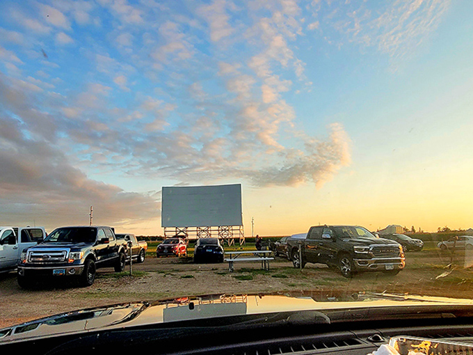Cars arrange themselves in neat rows like eager students, all facing the glowing teacher at the front of this unique outdoor classroom.