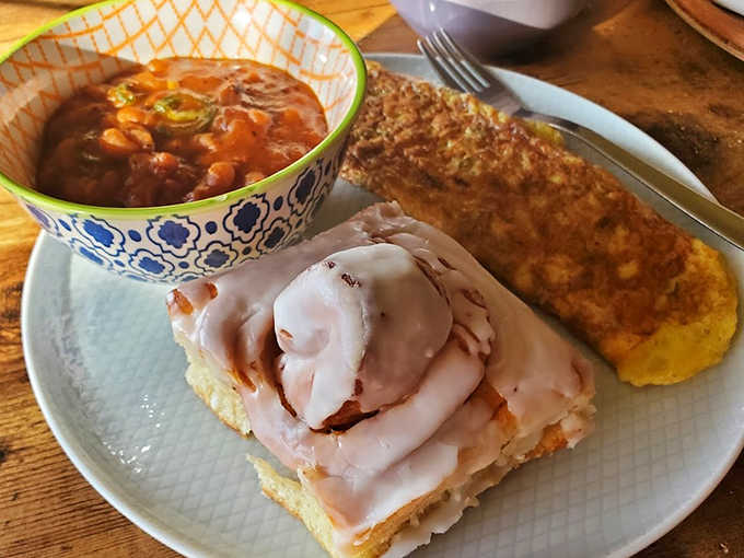 The perfect breakfast trinity: a soul-warming cinnamon roll, hearty soup, and cornbread that would make your grandmother nod in approval.