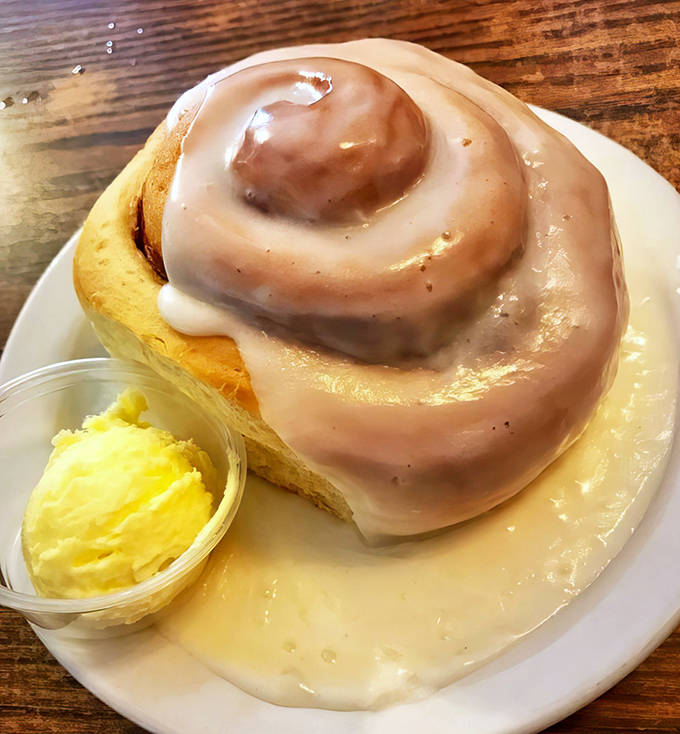 This isn't just any cinnamon roll &ndash; it's a spiral of happiness drowning in icing that makes Monday mornings bearable again.