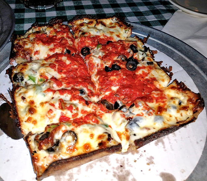 A garden of delights atop that famous rectangular crust, where black olives and green peppers find harmony in cheese and sauce.