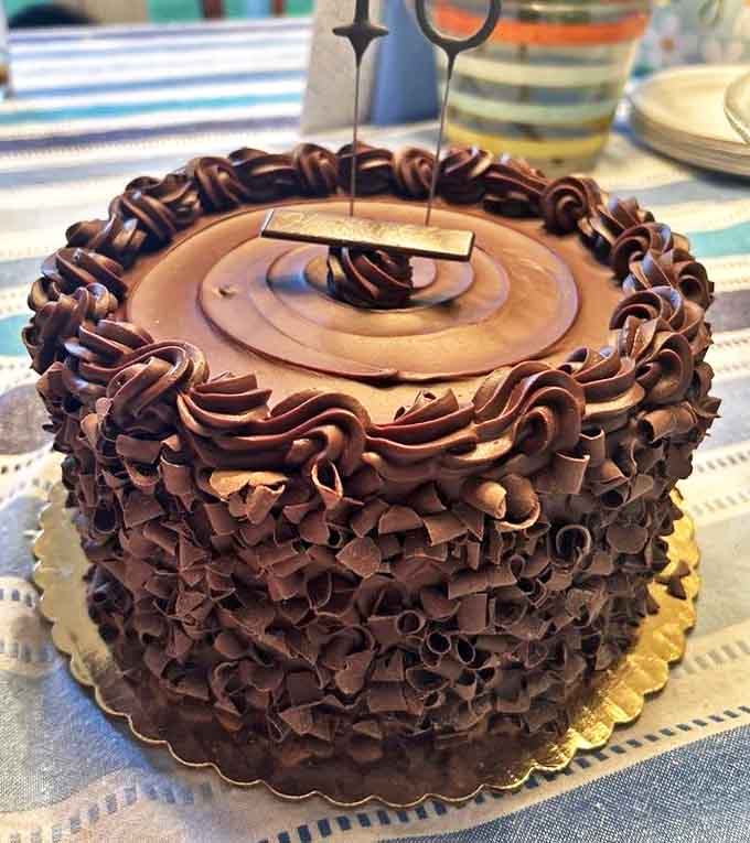 Chocolate doesn't just get layered here; it gets elevated to an art form with cascading curls that make you hesitate before destroying such beauty.