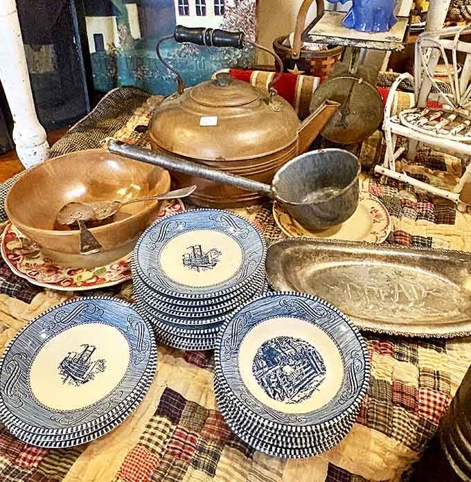 Blue and white transferware plates stack beautifully alongside vintage cookware, each piece having survived countless family gatherings through the decades.