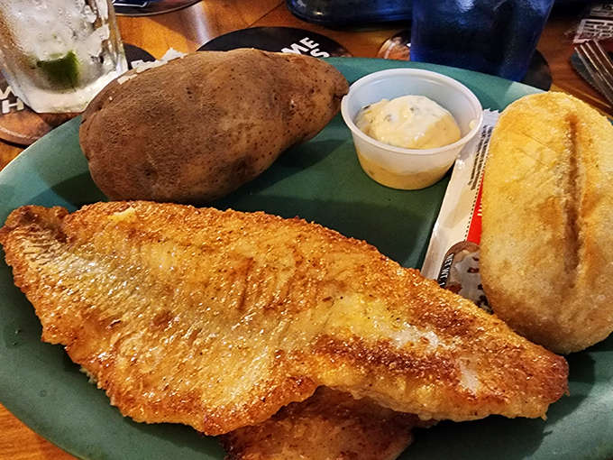 Golden-fried walleye, Minnesota's beloved state fish, served with a fluffy baked potato and warm roll &ndash; lake-to-plate perfection.
