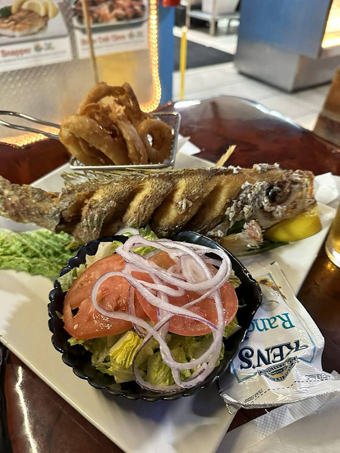 Crispy perfection meets tender flakiness in this whole fried snapper, served with all the fixings and zero pretension.