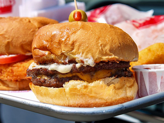 The famous Galley Boy in all its glory &ndash; two beef patties, melted cheese, and those mysterious dual sauces, crowned with the signature olive on a toothpick.