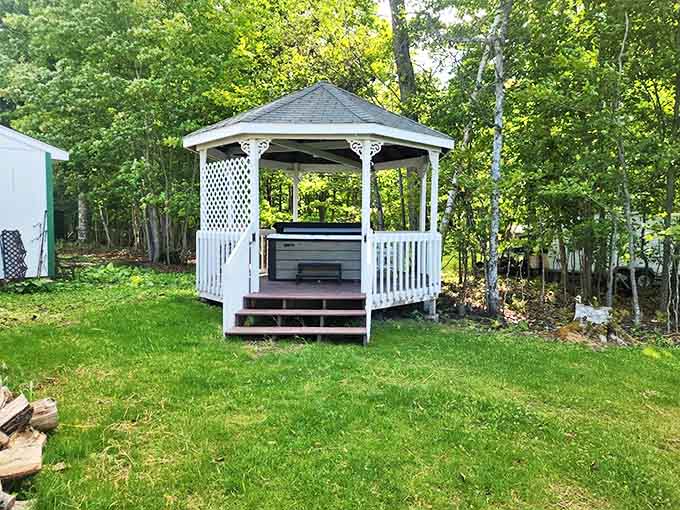 This charming gazebo houses more than just a hot tub &ndash; it's a portal to relaxation with a side of spectacular lake views.