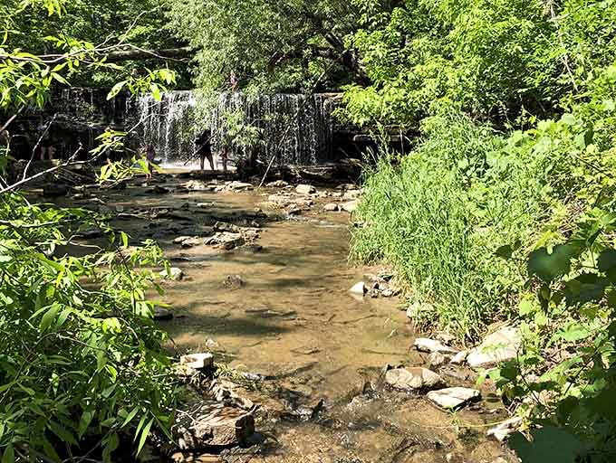 The rocky stream leading to the falls offers its own quiet beauty, reminding visitors that sometimes the journey really is as rewarding as the destination.