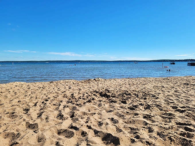 Crystal clear waters meet golden sand at Higgins Lake Beach, where you can see your toes and possibly your future vacation plans.