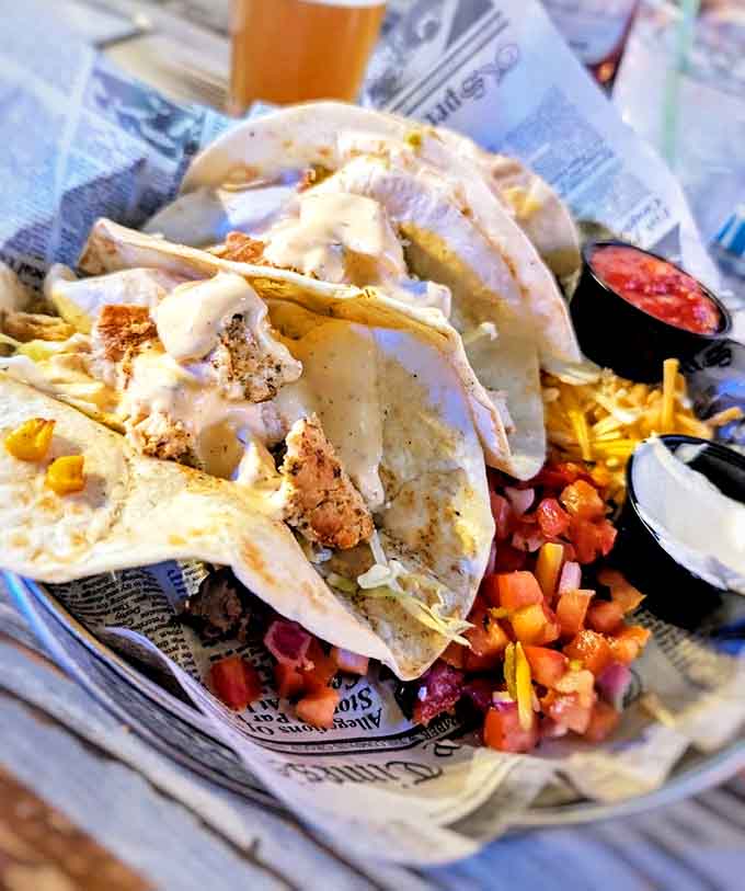 Jamaican jerk tacos bring Caribbean heat to Michigan shores, with perfectly seasoned fish nestled in soft tortillas and topped with cooling sauce.