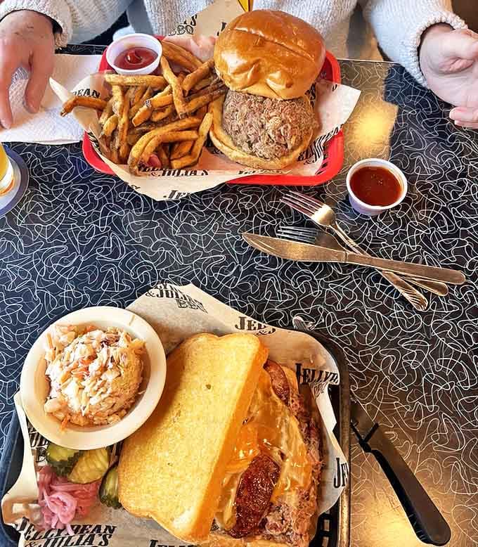 Barbecue artistry on display &ndash; tender pulled pork and brisket sandwiches flanked by golden fries and creamy slaw.