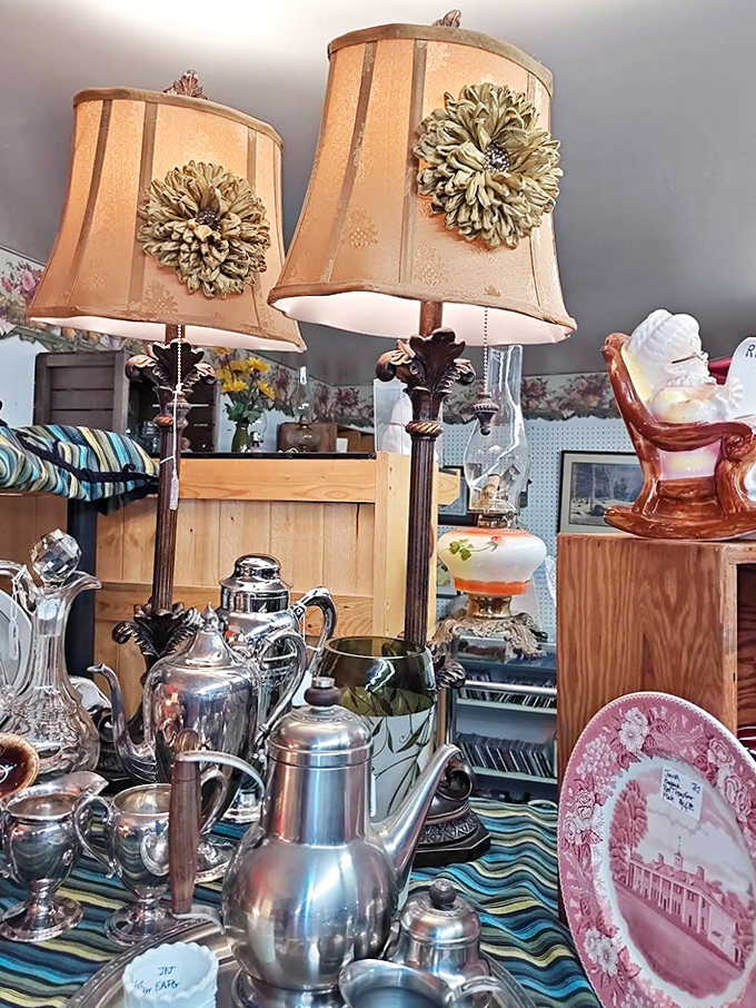 Elegant lampshades cast a warm glow over silver tea services, creating the perfect vignette of bygone elegance.