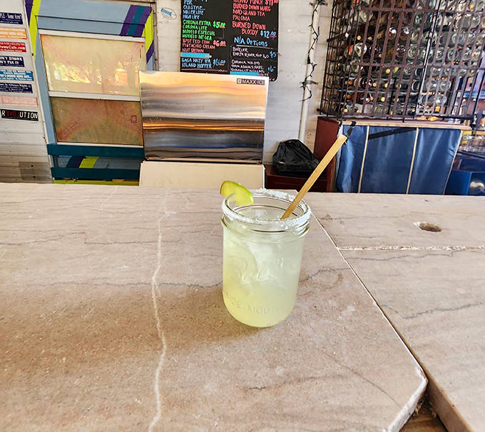 A refreshing lemonade served in a mason jar &ndash; because at Tom's, even the simplest drinks deserve a touch of rustic charm.